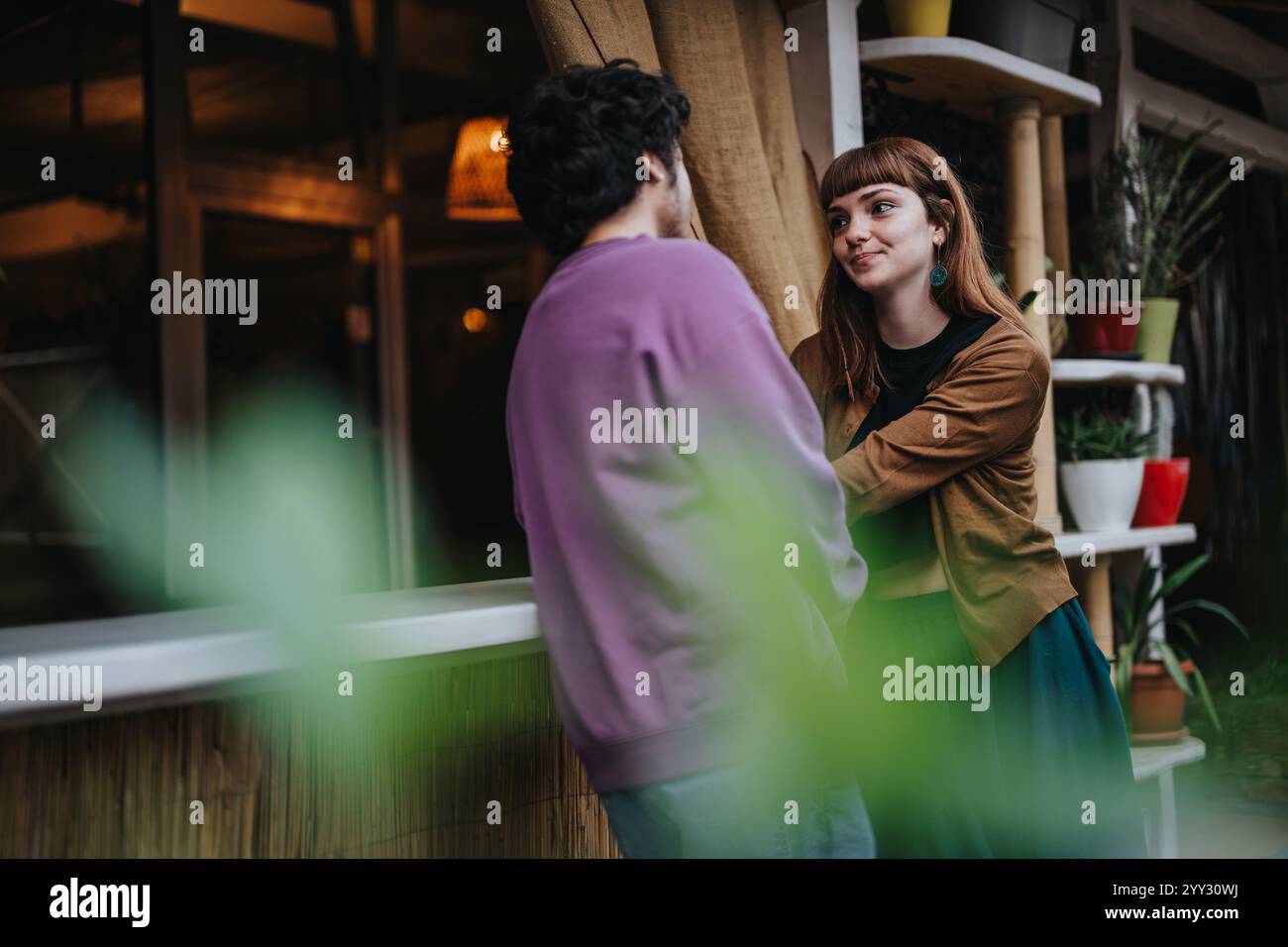 Friendly conversation between two people in a cozy cafe setting Stock ...