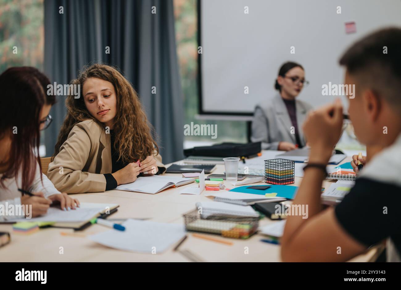 Students collaborating during a group study session in a classroom Stock Photo - Alamy