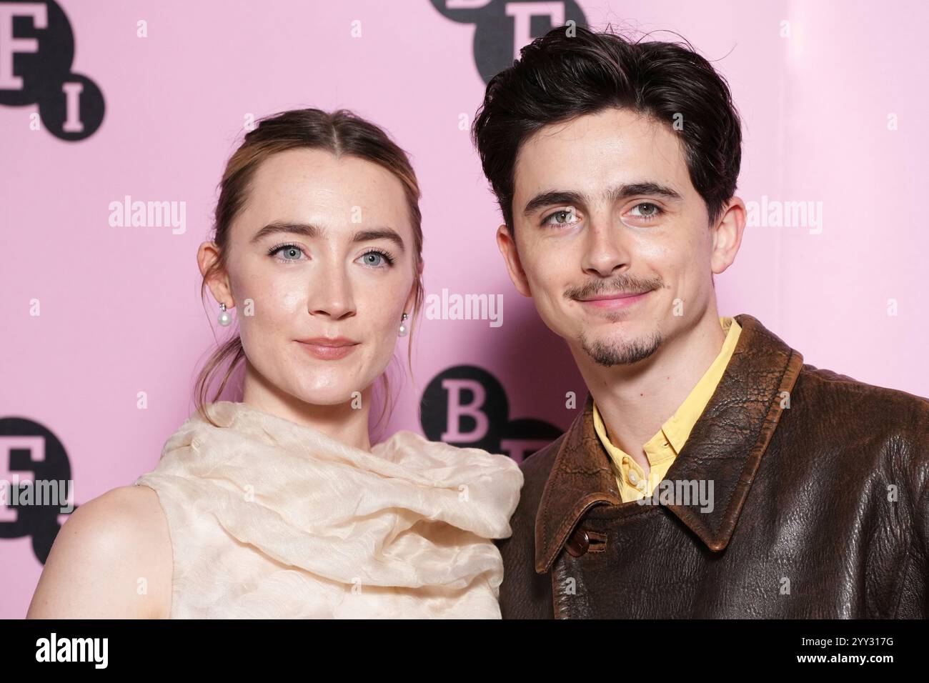 Saoirse Ronan, left, and Timothee Chalamet pose for photographers upon ...