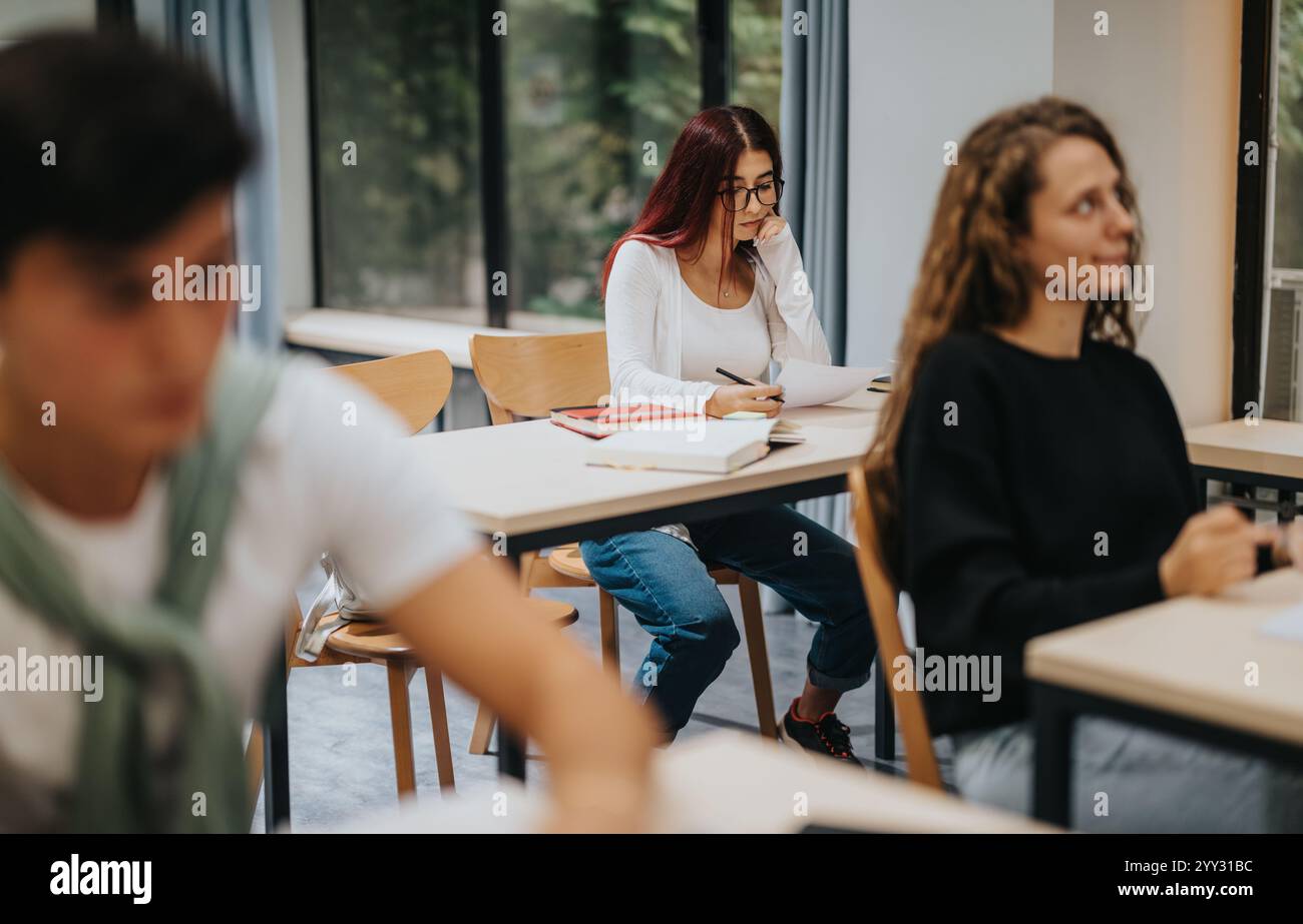 Students engaged in classroom learning and taking notes Stock Photo - Alamy