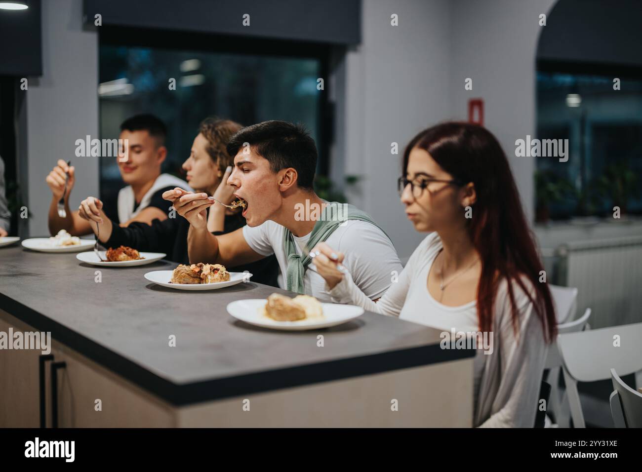 High school students enjoying lunch in a cafeteria setting Stock Photo ...