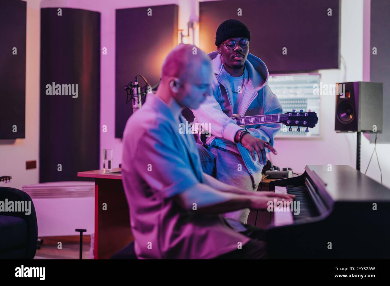 Musicians collaborating and creating music in a modern studio setting ...