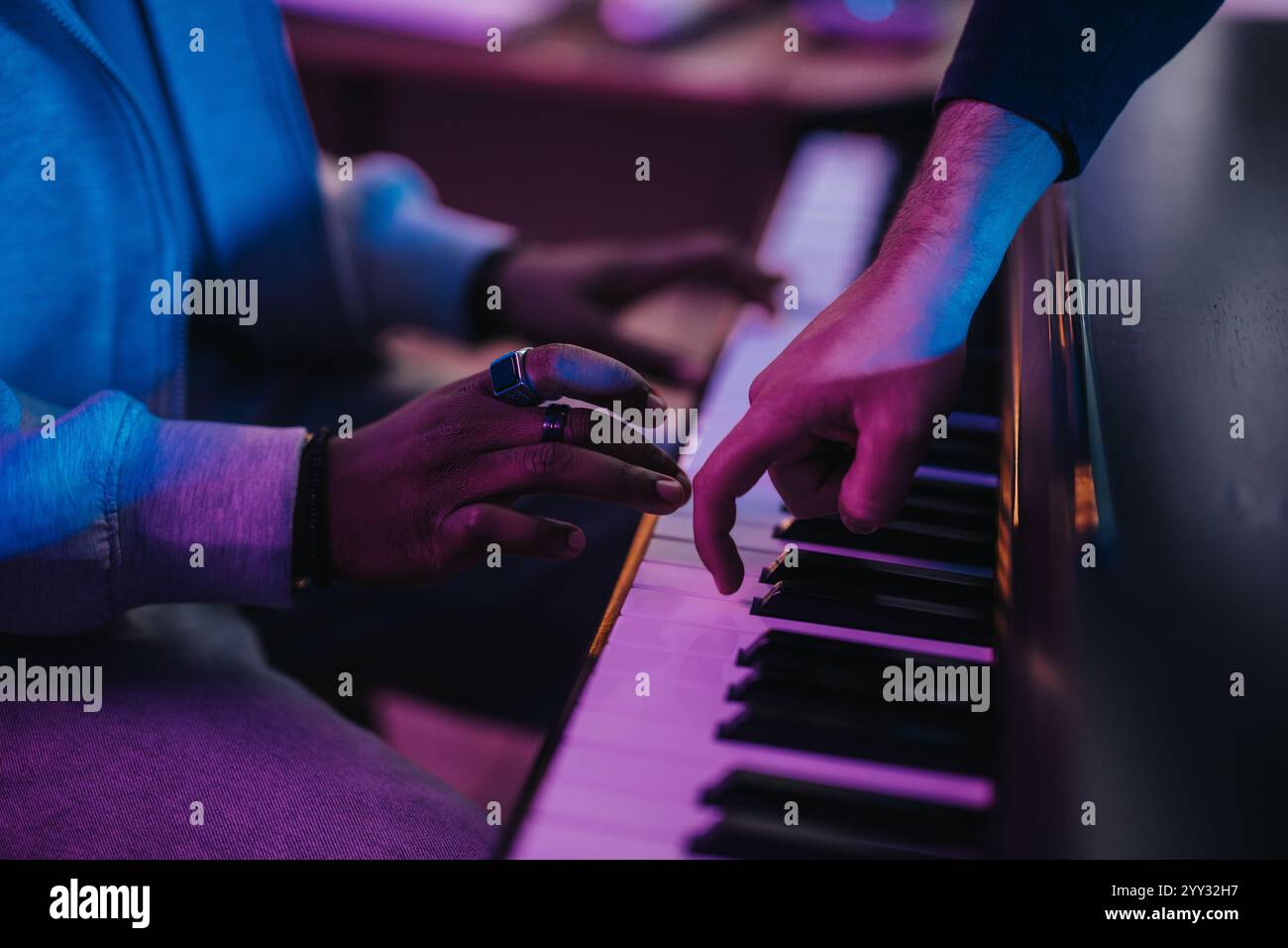 Musicians collaborating in a studio setting with a piano keyboard Stock ...