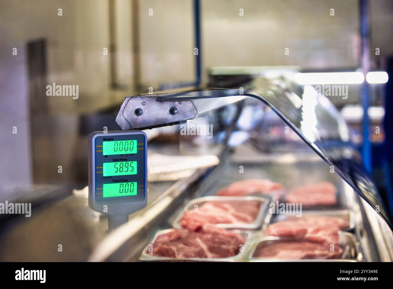 african butcher shop, meat on in the display, electronic scale to ...