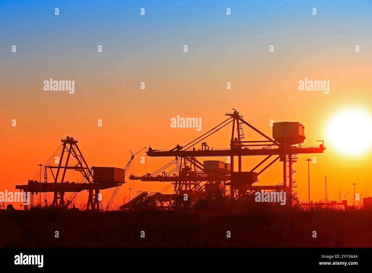 Port crane unloading container ships Stock Photo - Alamy