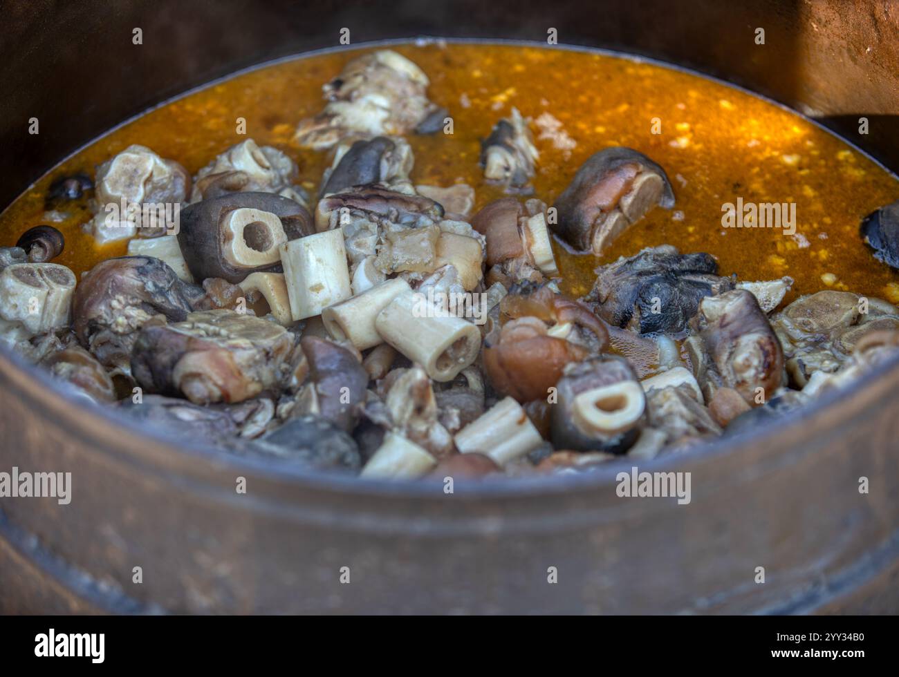 pot of traditional boiled stew cow heels outdoors, african street ...