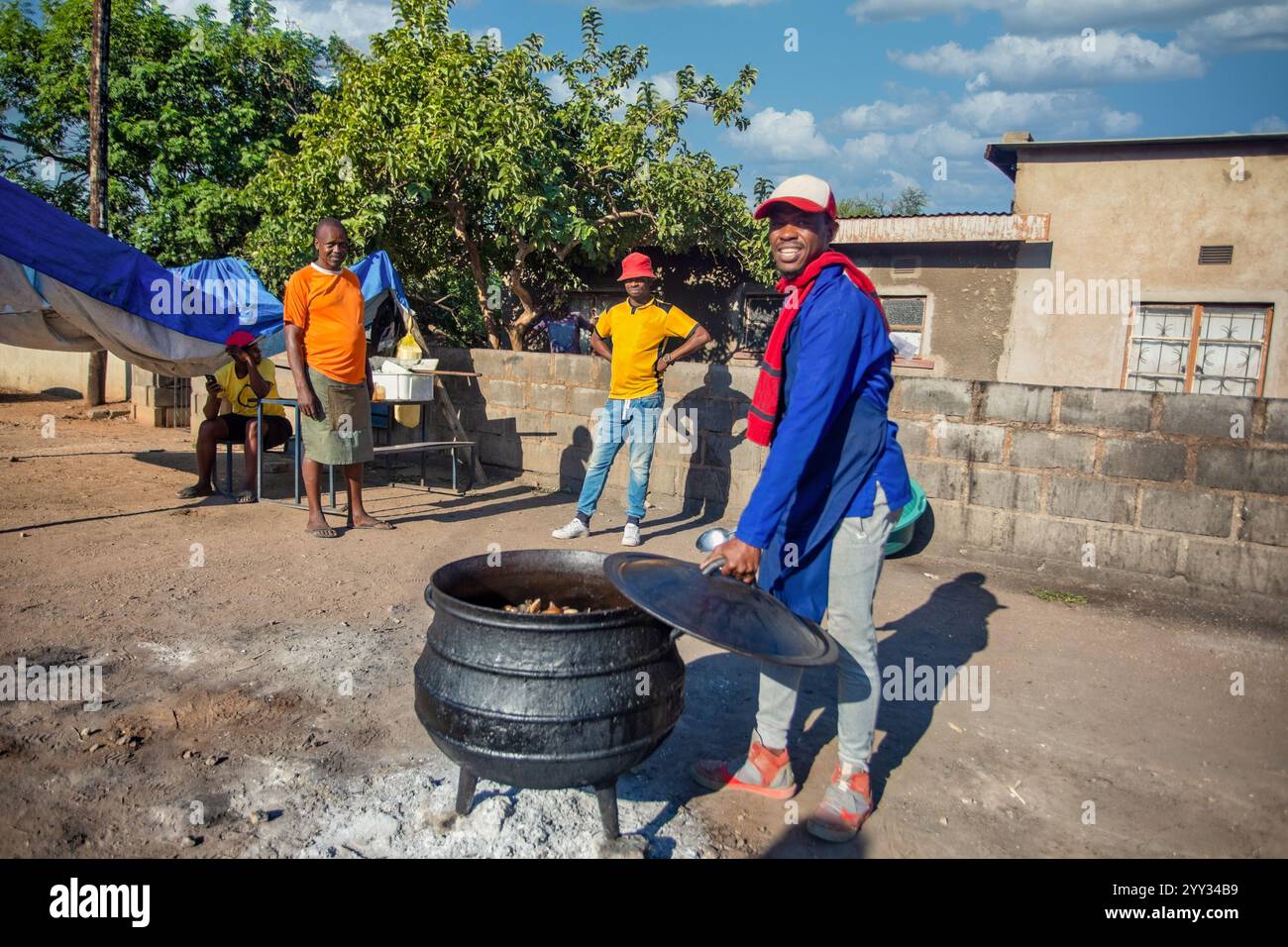 street vendor, man cooking traditional Botswana food boiled cow heels ...
