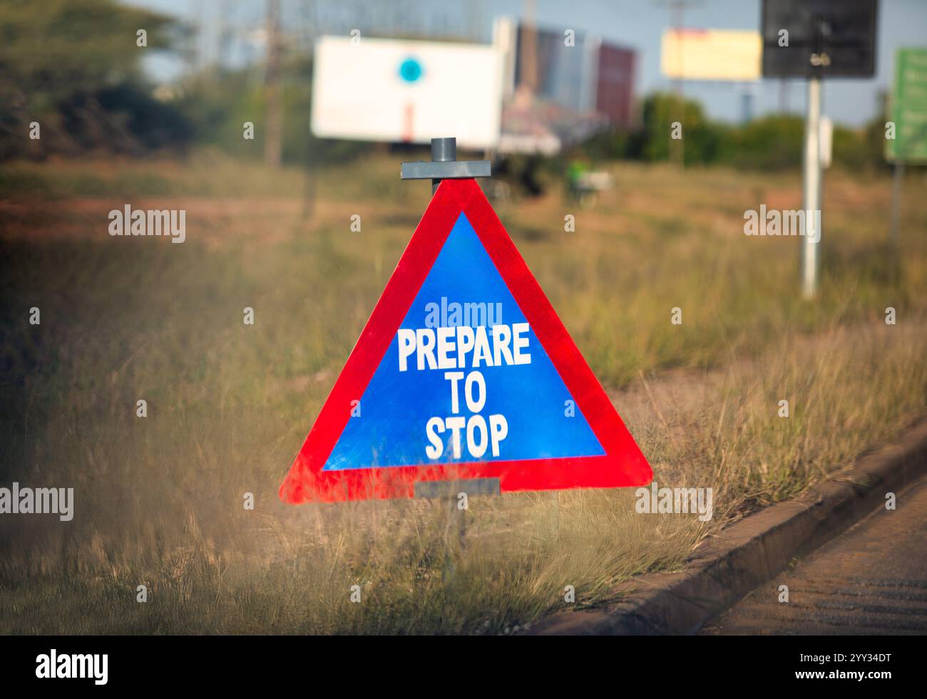 prepare to stop sign triangle by the side of the road, town city ...