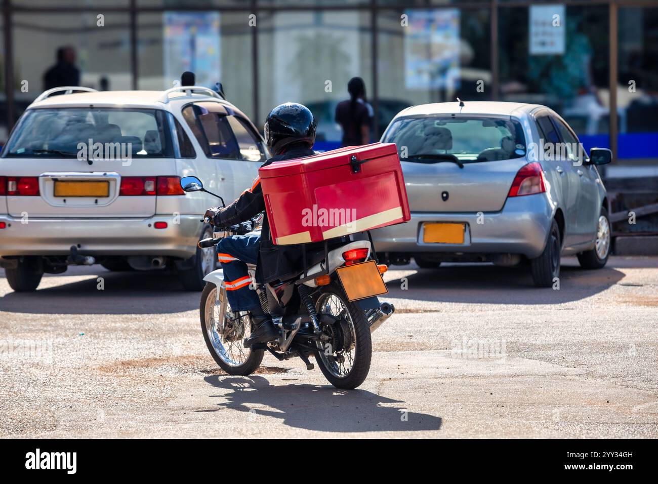 Delivery driver on motorcycle hi-res stock photography and images - Alamy