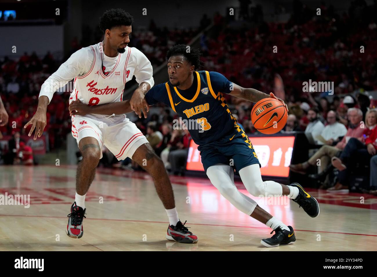 Houston guard Mylik Wilson (8) defends against Toledo guard Sonny ...