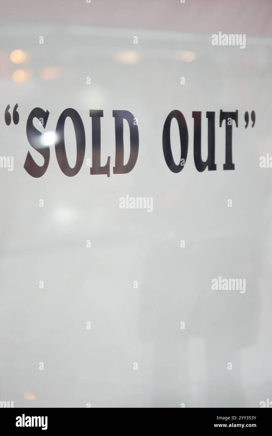A Sold Out Sign is Clearly Displayed in the Retail Store Window Stock ...