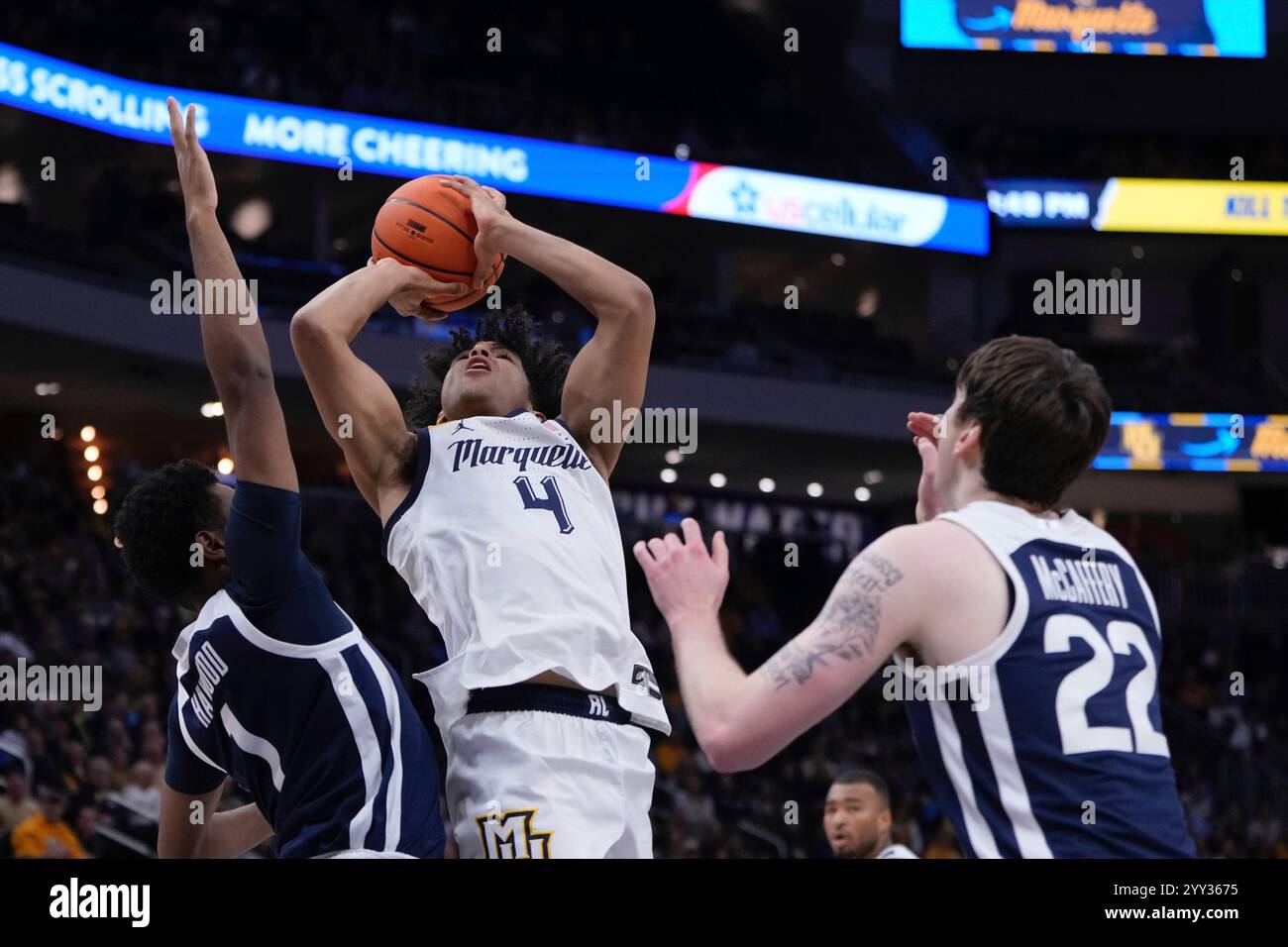 Marquette's Stevie Mitchell is fouled by Butler's Evan Haywood during ...