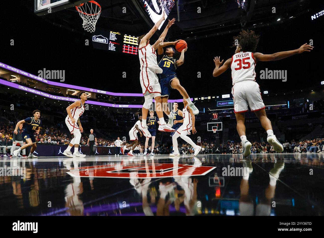 Michigan guard Rubin Jones (15) drives to the basket against Oklahoma ...