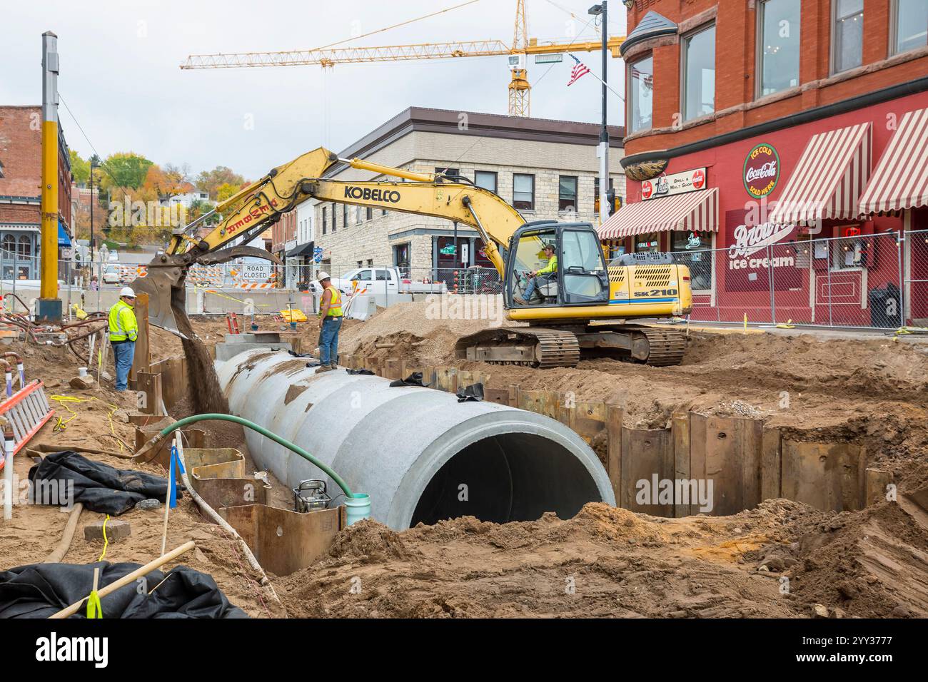 Construction crew upgrading sewer lines in small downtown area Stock ...