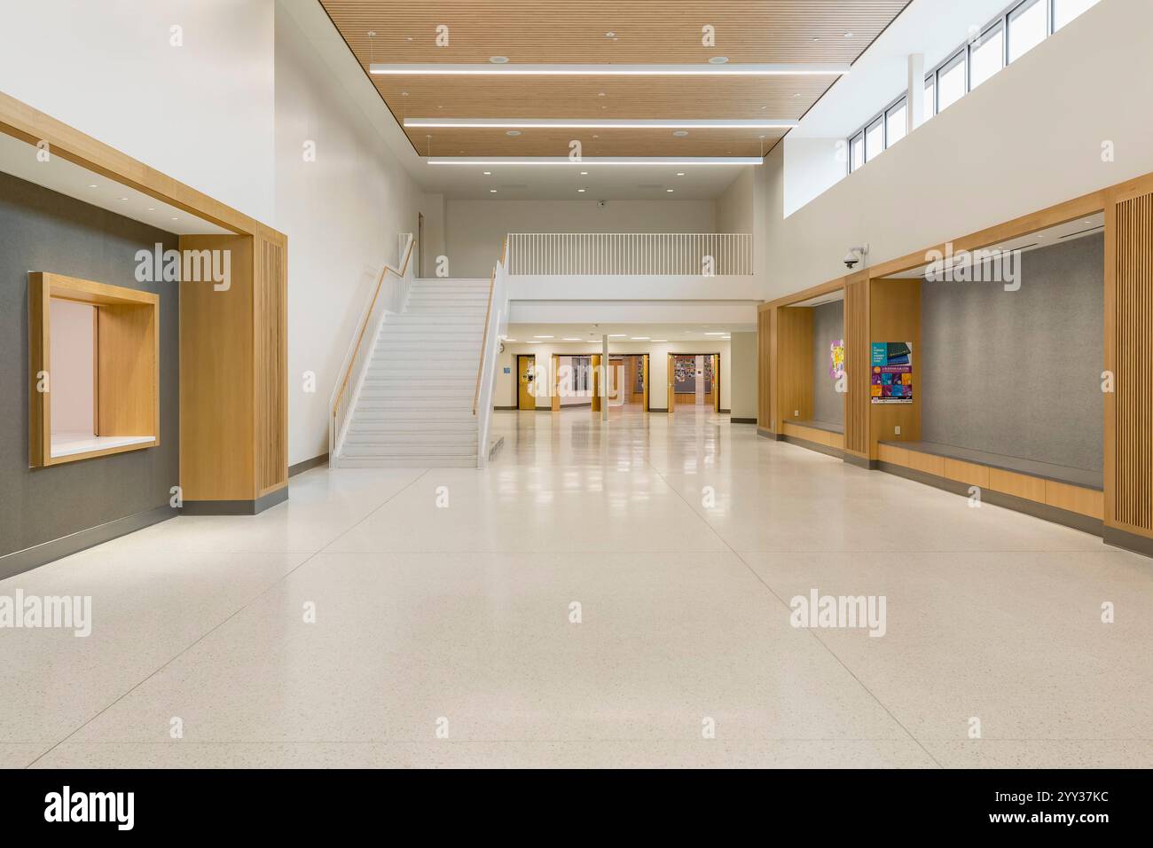Middle school entrance hall with wood paneled seating areas Stock Photo ...