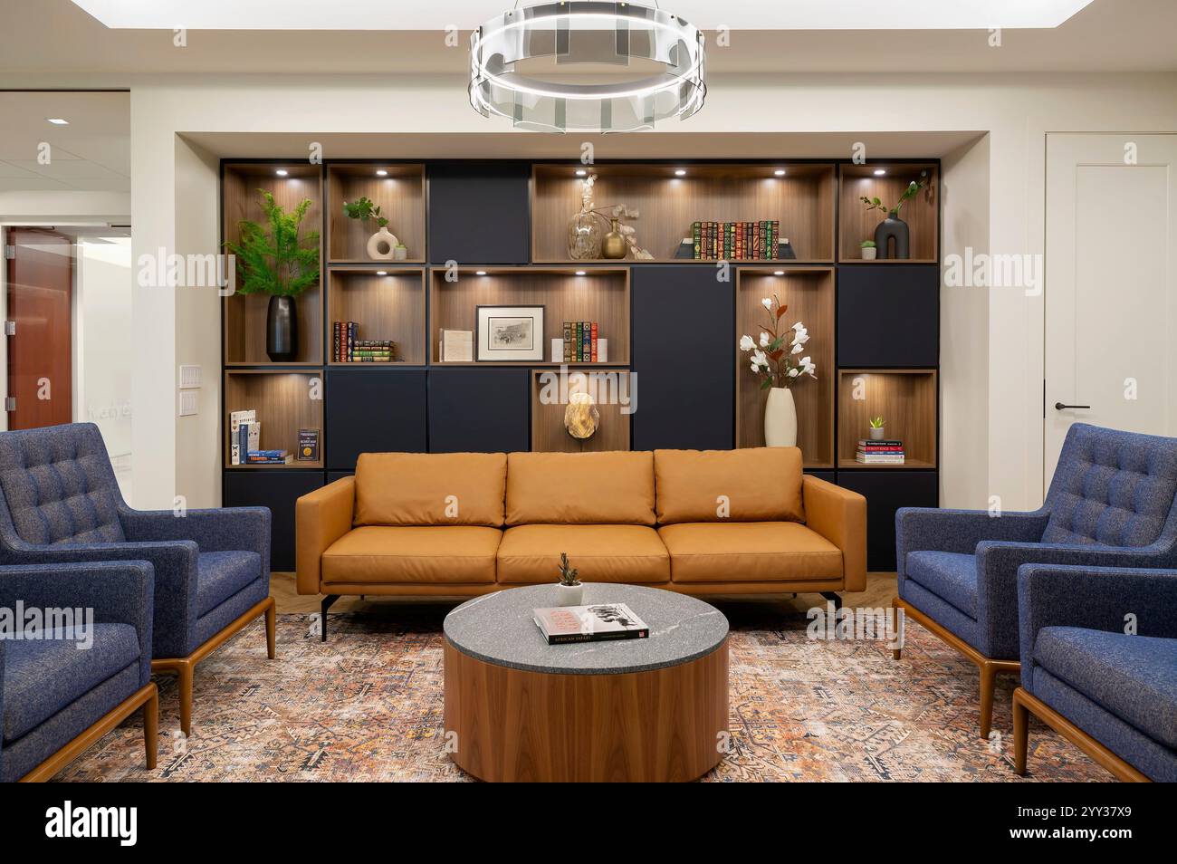 Reception area in office space with seating and shelving Stock Photo ...