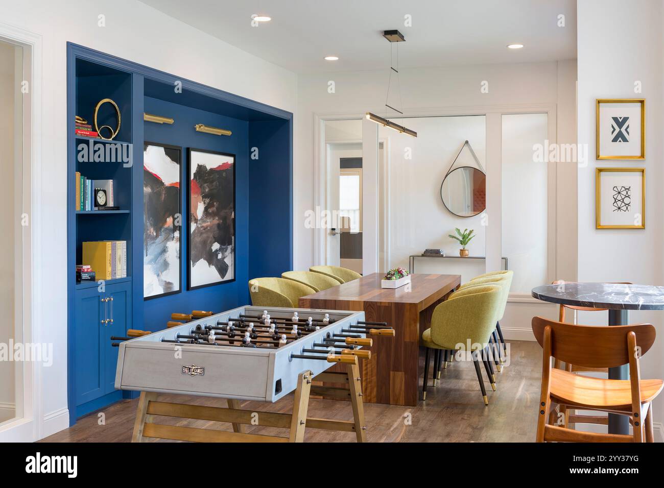 Dining and game area in apartment building clubhouse with dining table ...