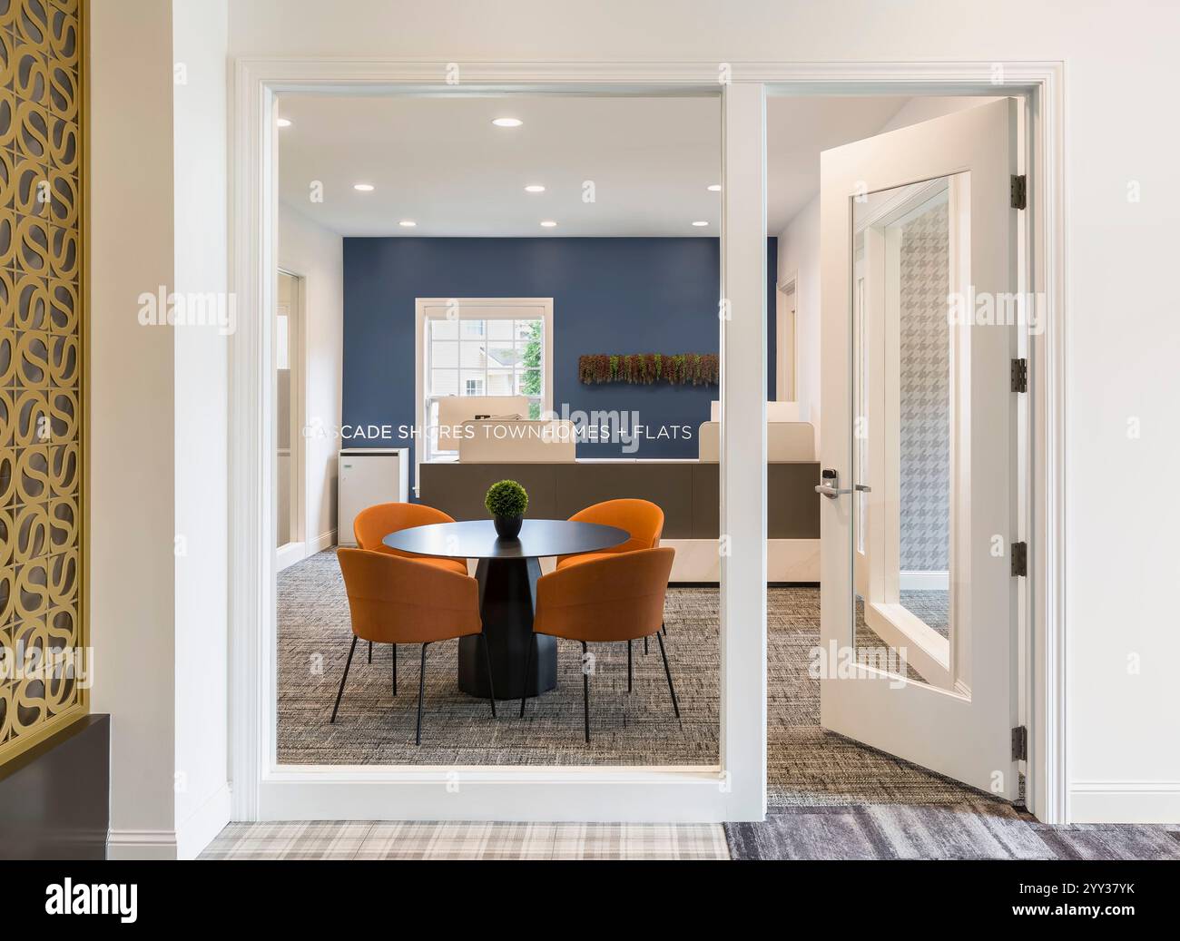 View into front office of apartment building through glass window and ...