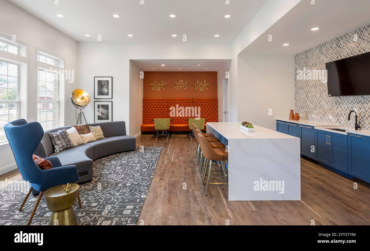 Colorful touches in kitchen and seating area of apartment building ...