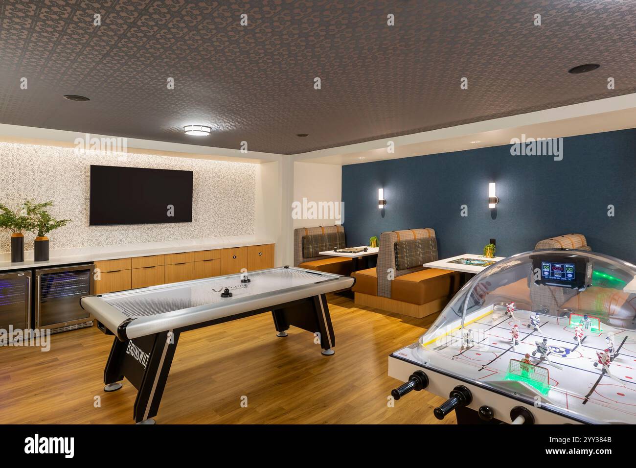 Game room in clubhouse of apartment building with air hockey and table ...