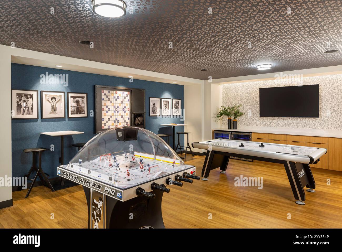 Game room in clubhouse of apartment building with air hockey and table ...