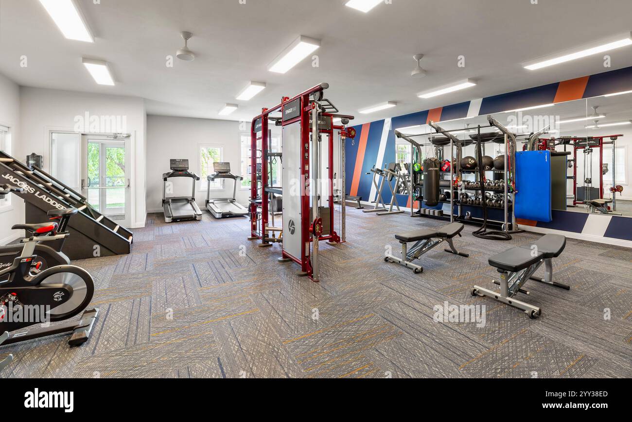 Fitness room in apartment complex with exercise machines and weight ...