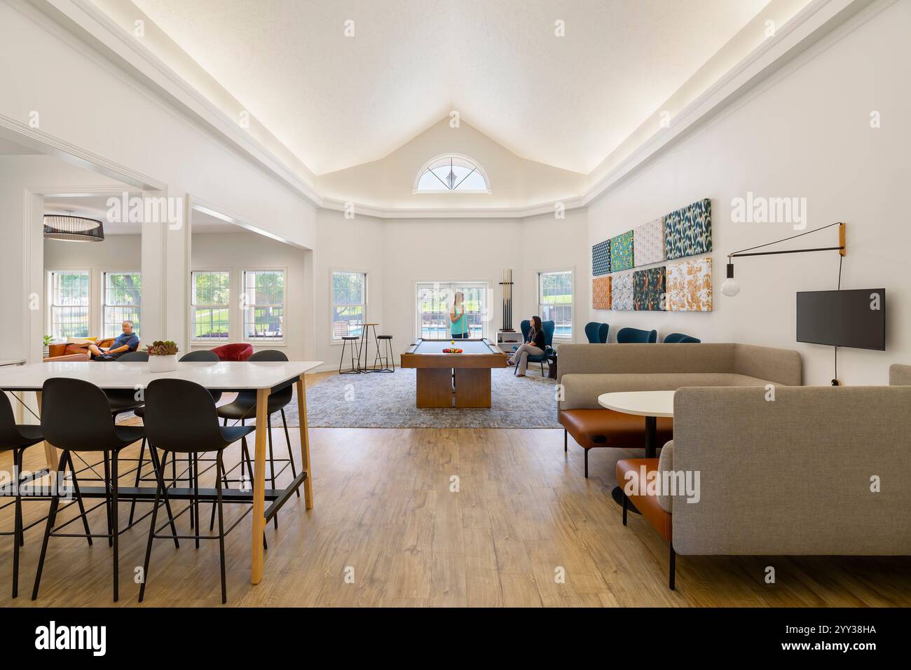 People enjoying the clubhouse at an apartment complex with seating and ...