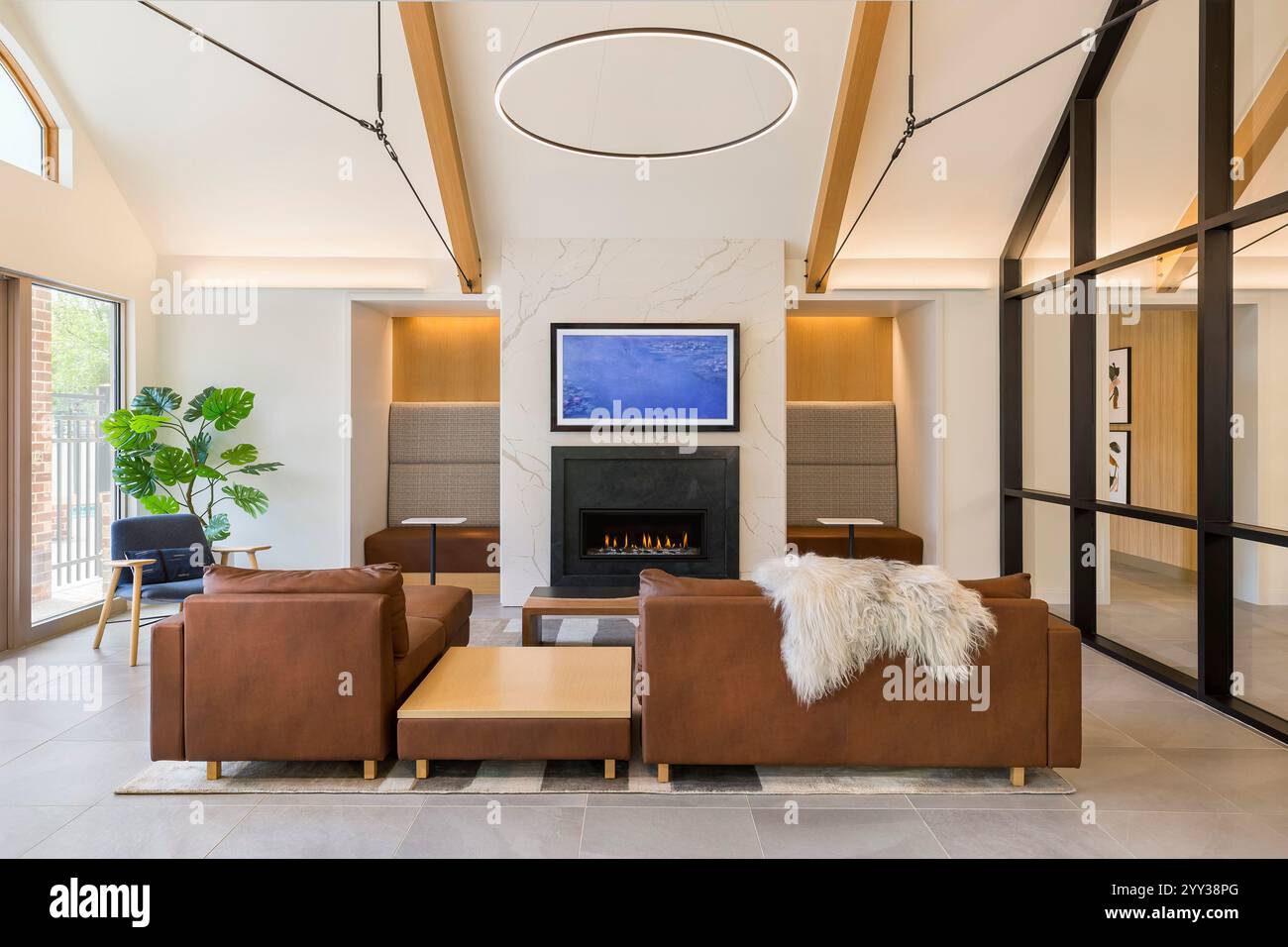 Clubhouse lounge of apartment building with television, fireplace and ...