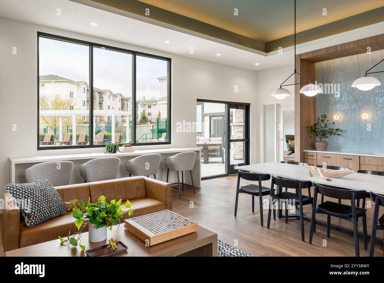 Community room in apartment building with kitchen and seating and large ...