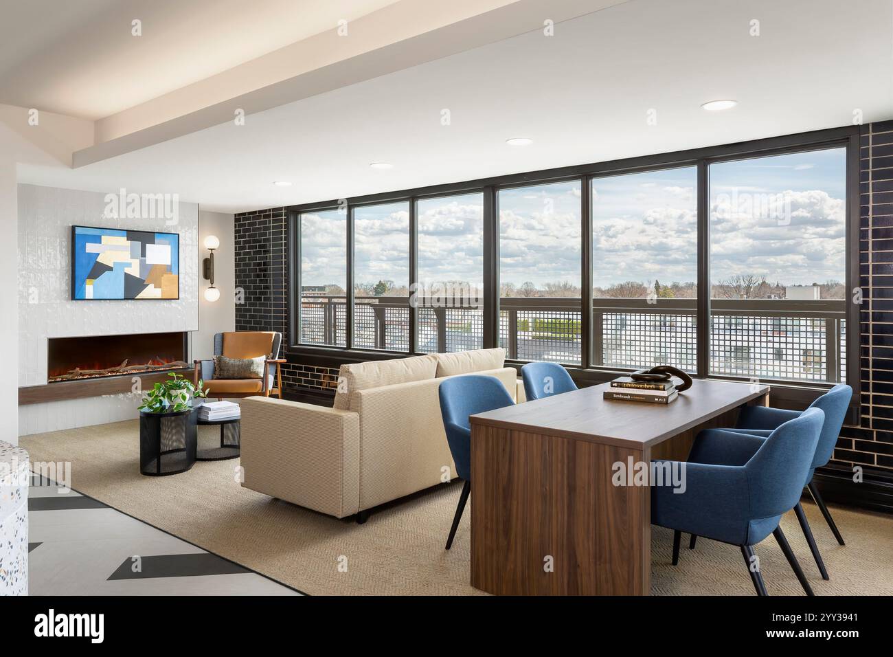 Seating area with fireplace in community room on top floor of apartment ...