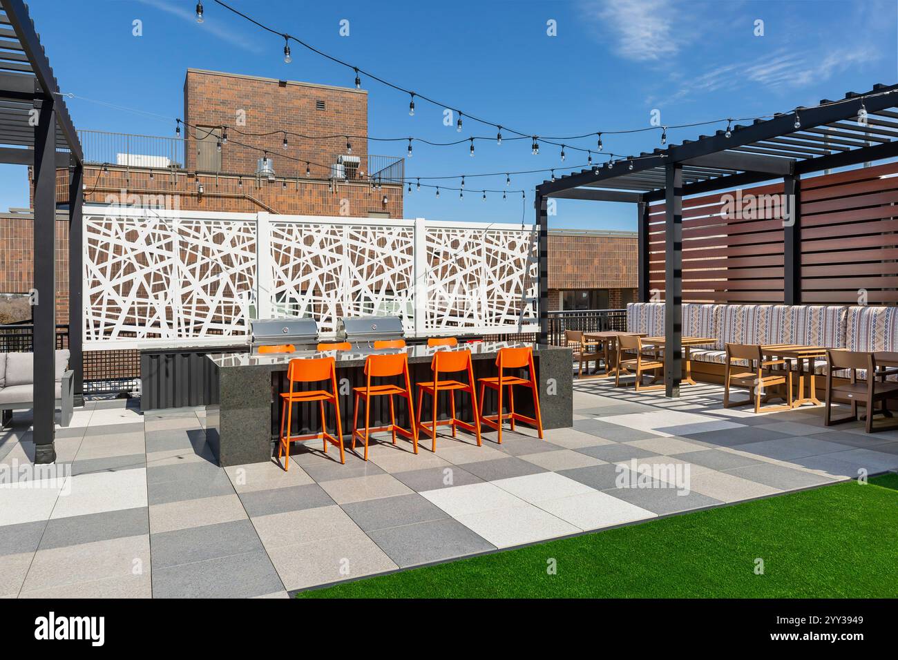 apartment building roof deck showing grill area with decorative white ...