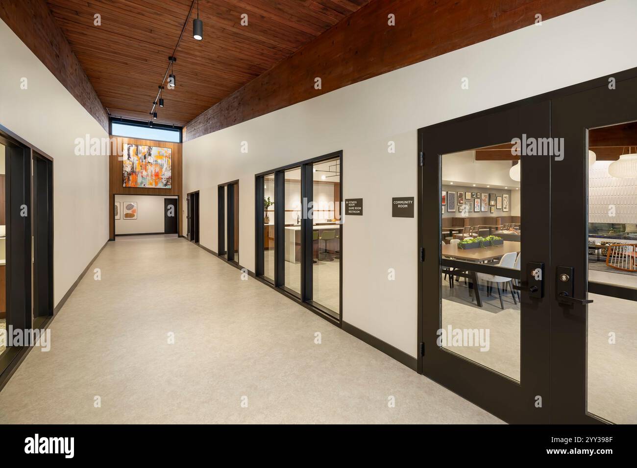 Hallway in apartment building clubhouse with view into community room hi-res stock photography ...