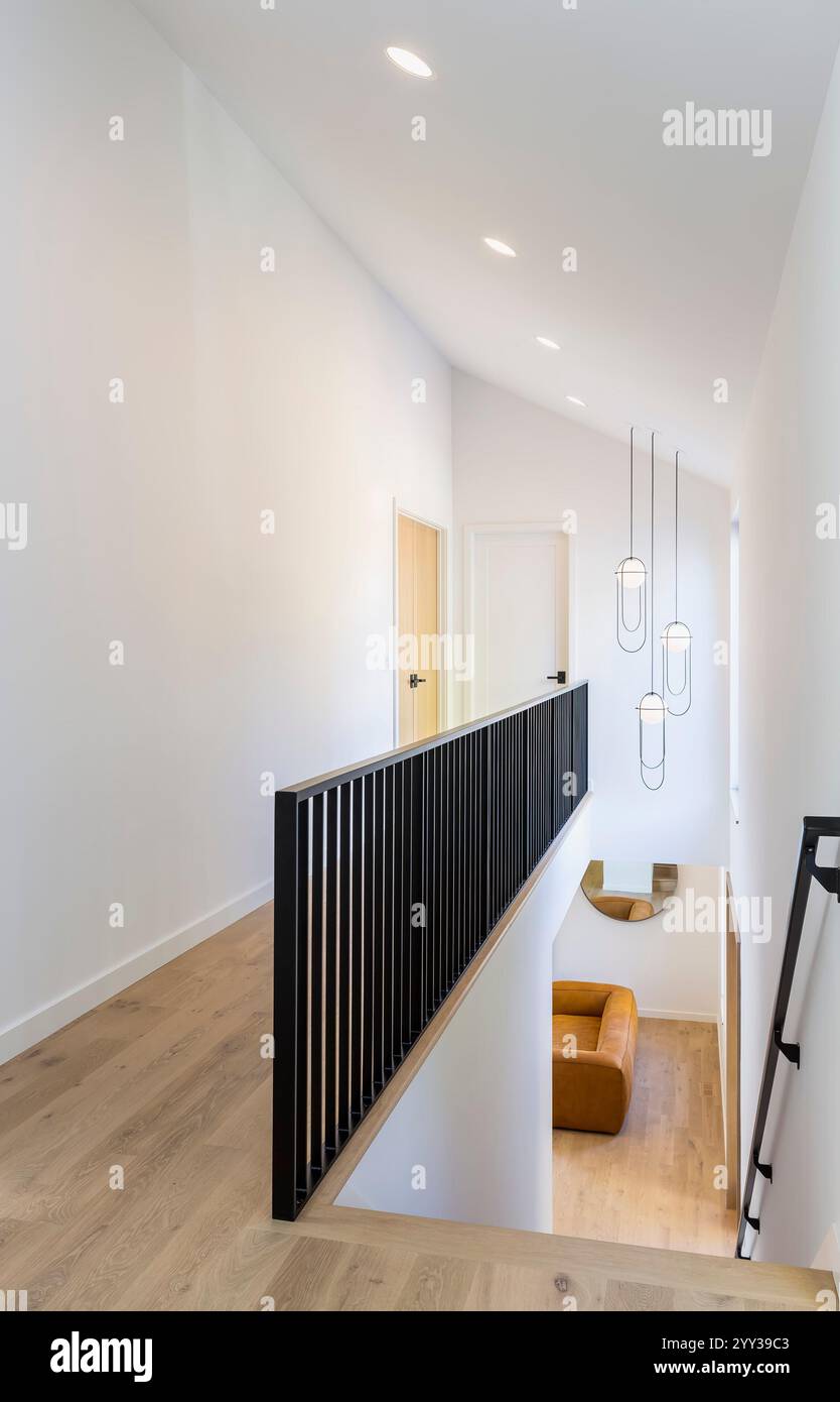 Second floor landing of modern home showing black wrought iron railing ...