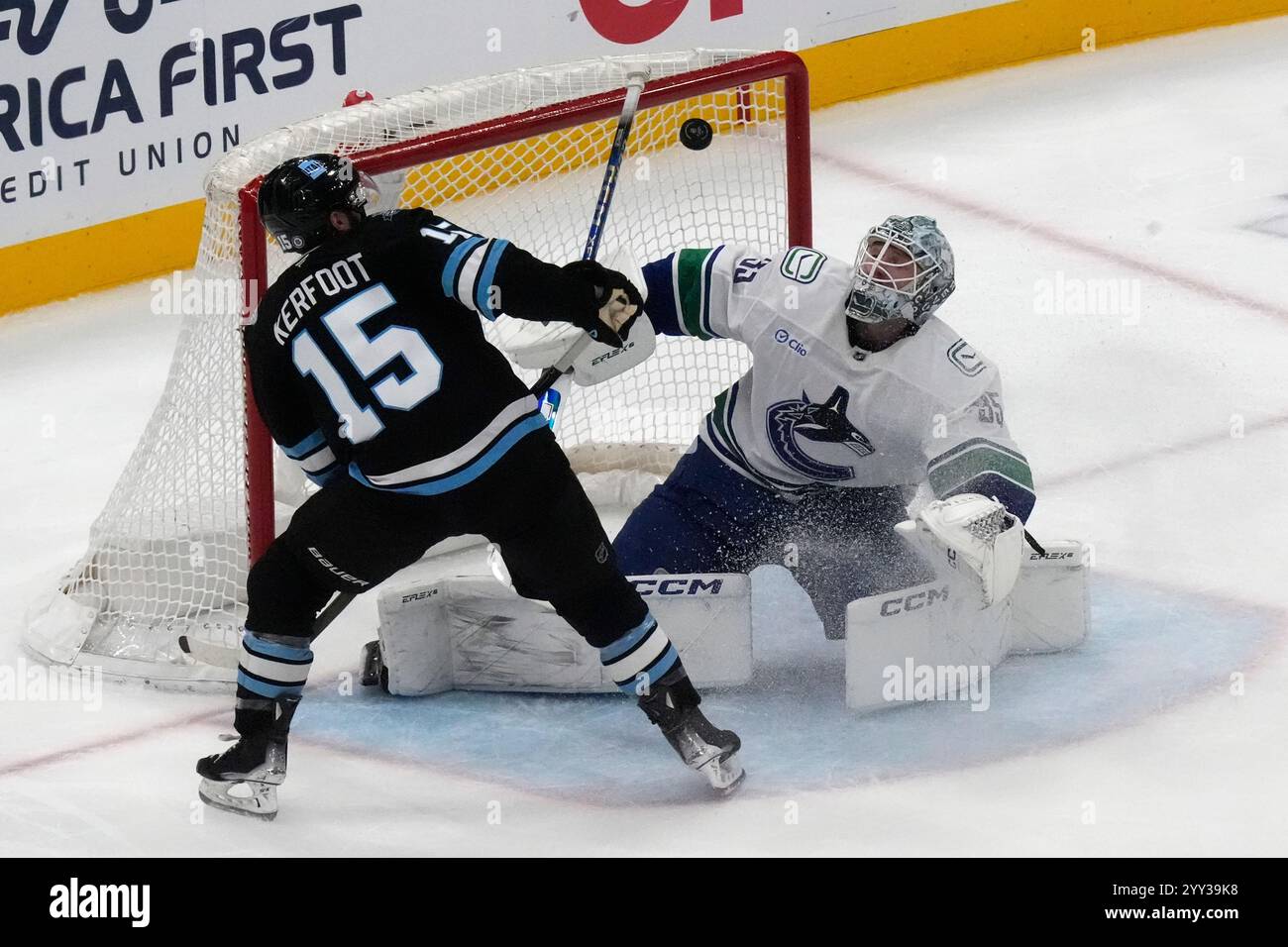 Vancouver Canucks goaltender Thatcher Demko, right, makes a save ...