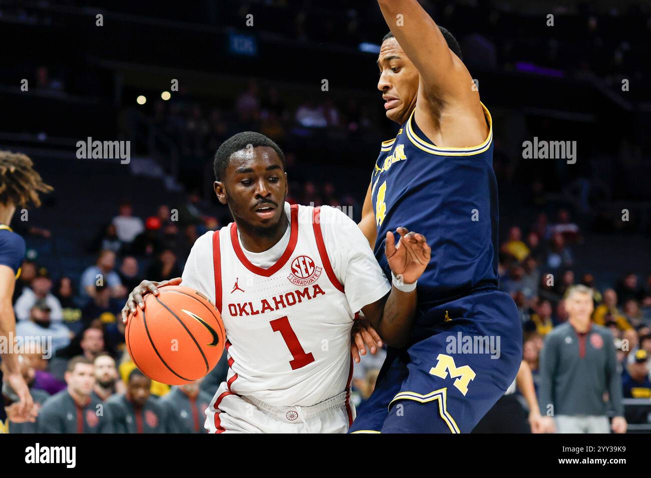 Oklahoma guard Kobe Elvis (1) drives into Michigan guard Nimari Burnett ...