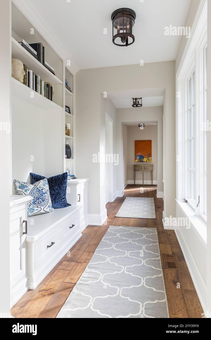 Bright hallway of house with built-in shelves and storage Stock Photo ...