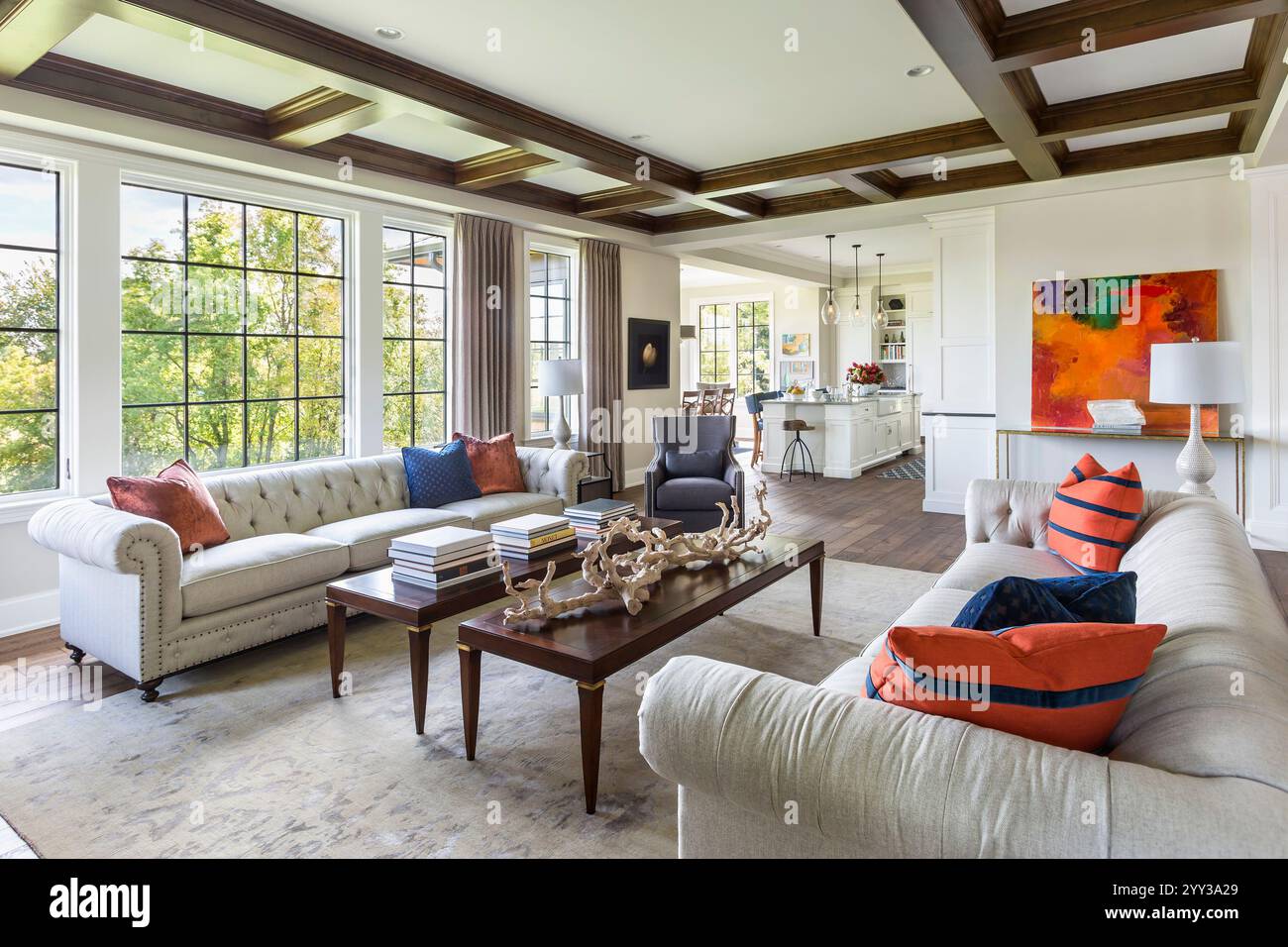 Upscale living room with neutral colors and accents of bright orange ...