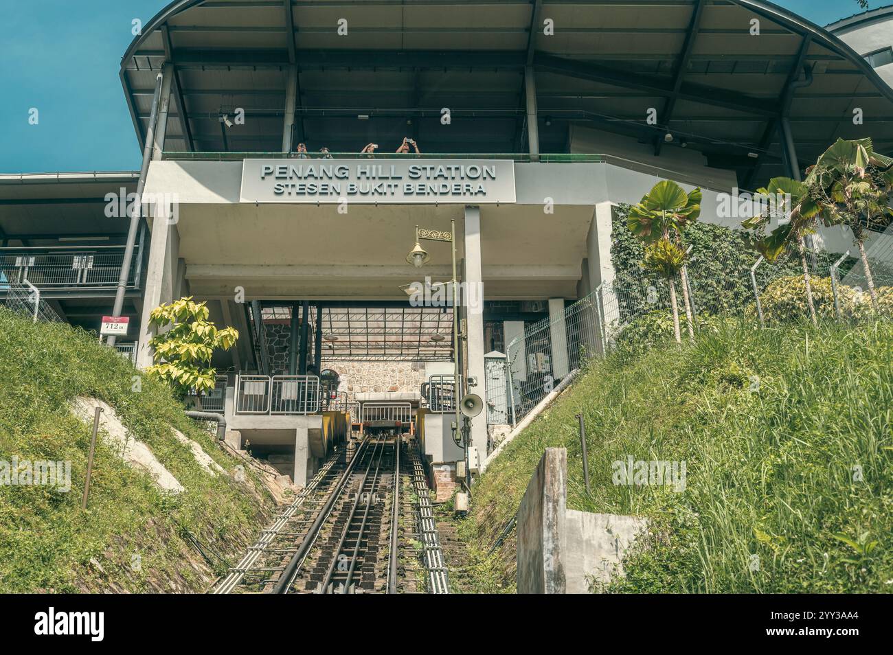 Penang Hill station entrance with funicular railway tracks, lush ...
