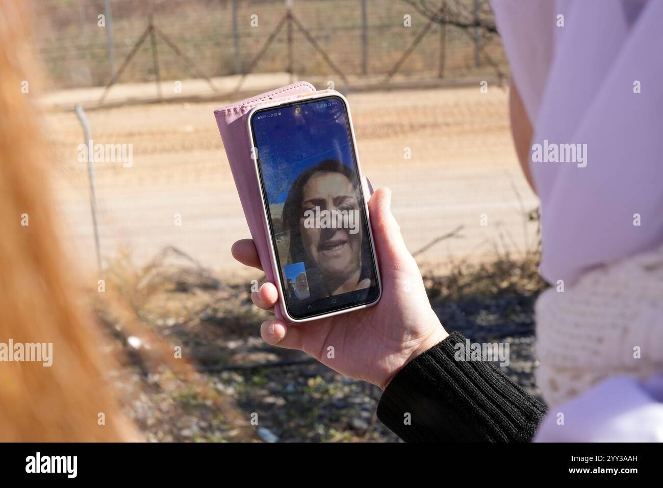 Samar Safadi holds her phone as she talks by video call with her sister ...