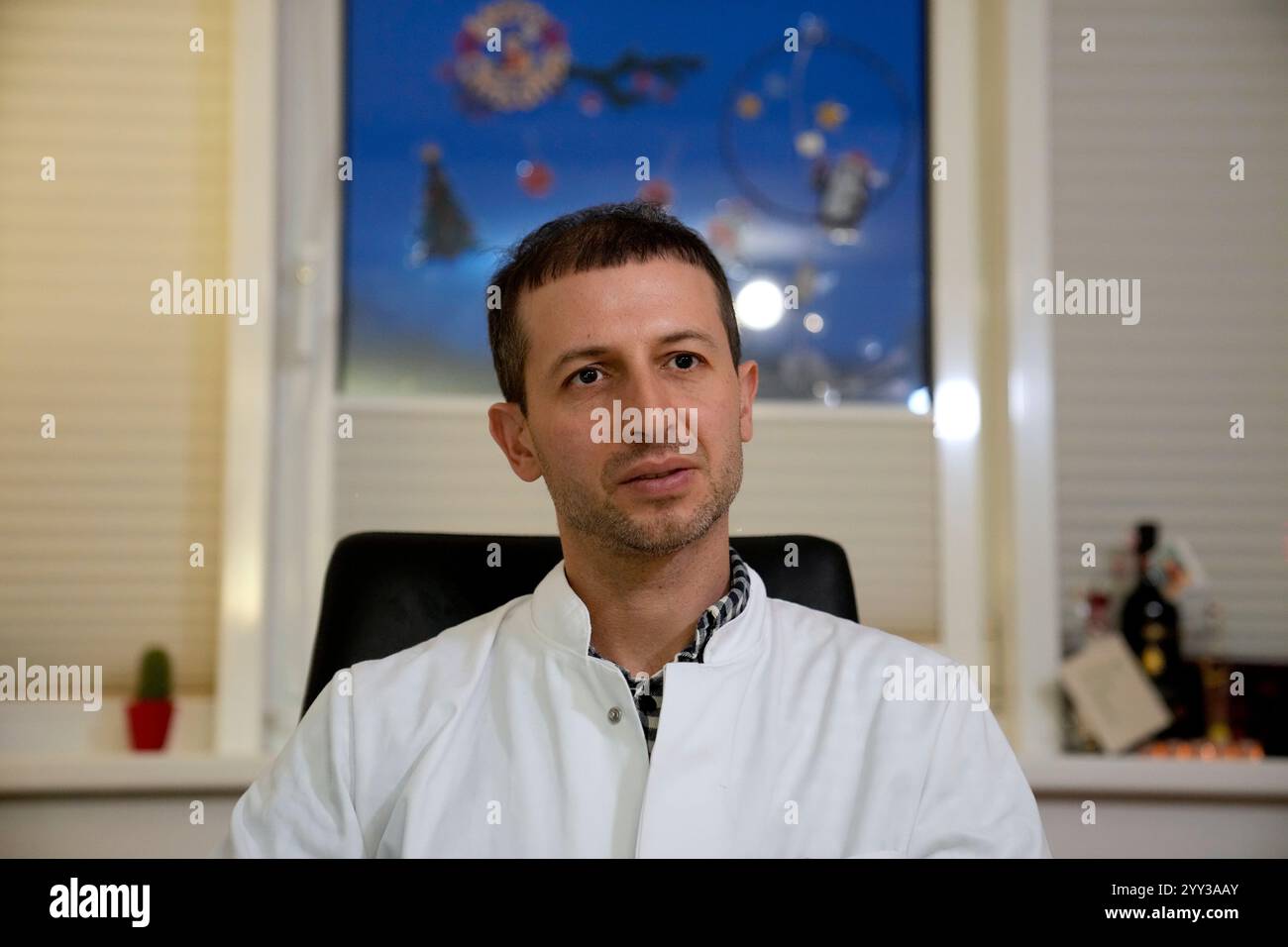 Syrian doctor Ayham Darouich, 40, attends an interview with the ...