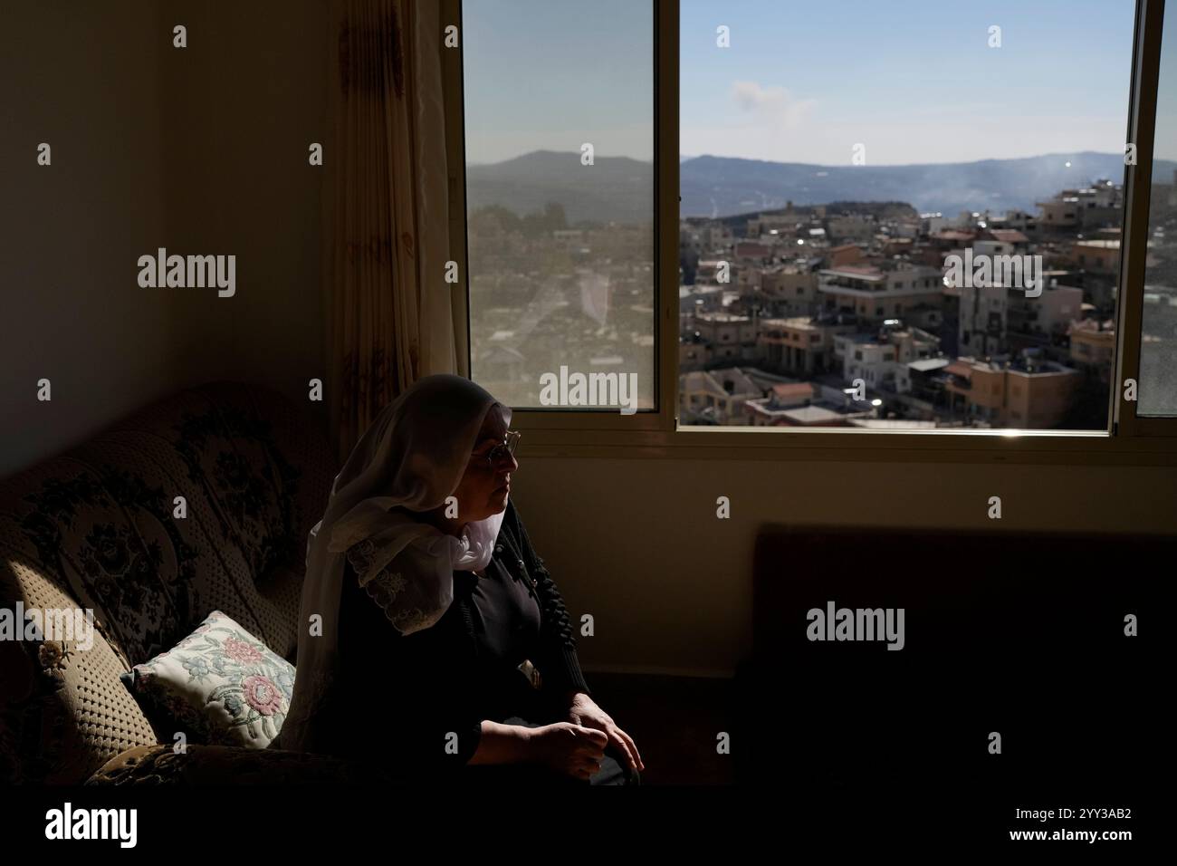 Samar Safadi sits next to a window after speaking by phone with her ...