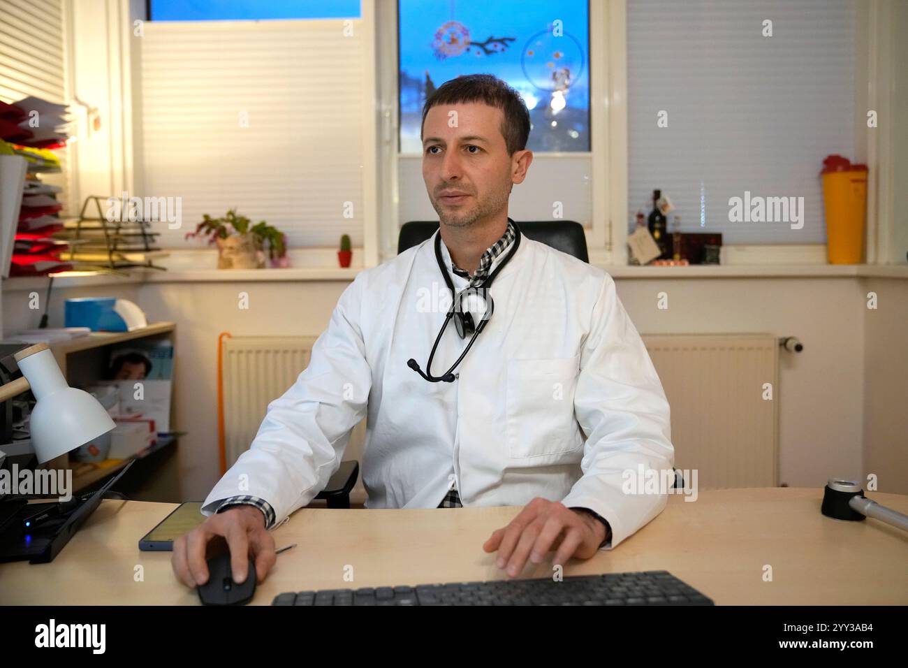 Syrian doctor Ayham Darouich, 40, works in his doctor's office in ...