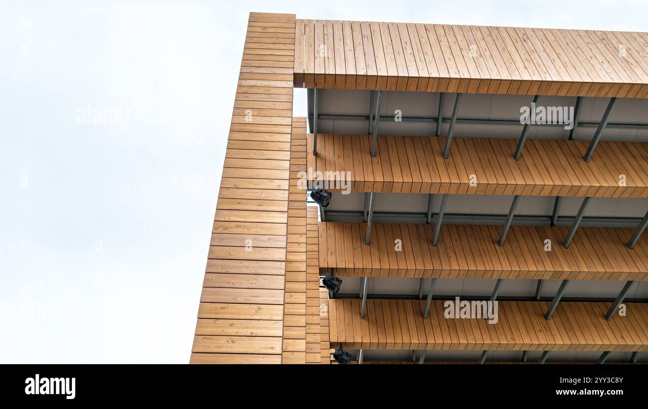 Modern wooden architectural design of outdoor stage with stacked beams ...