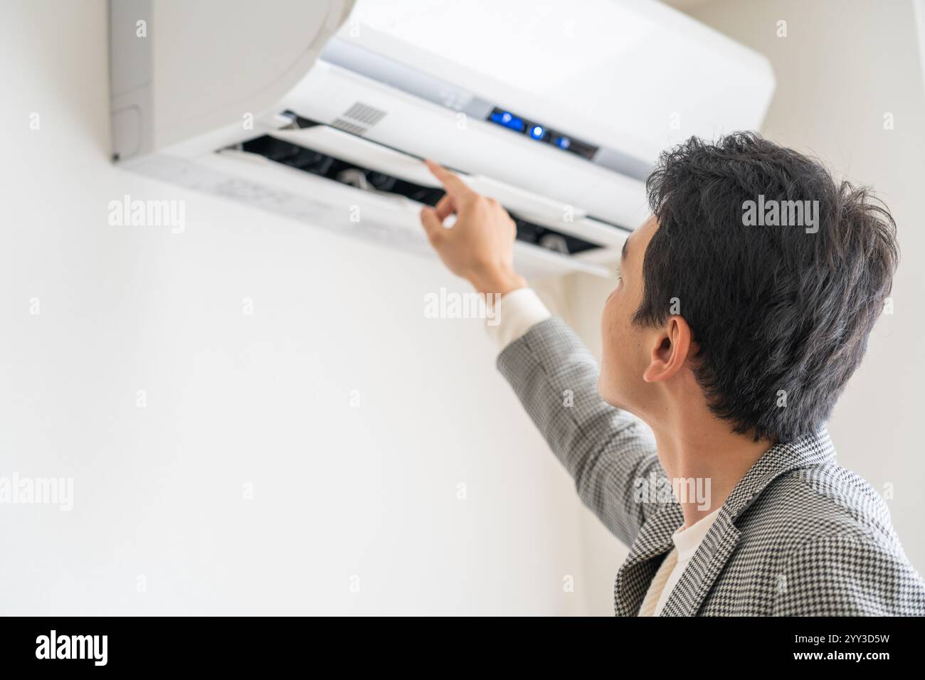 Young man air conditioner hi-res stock photography and images - Alamy