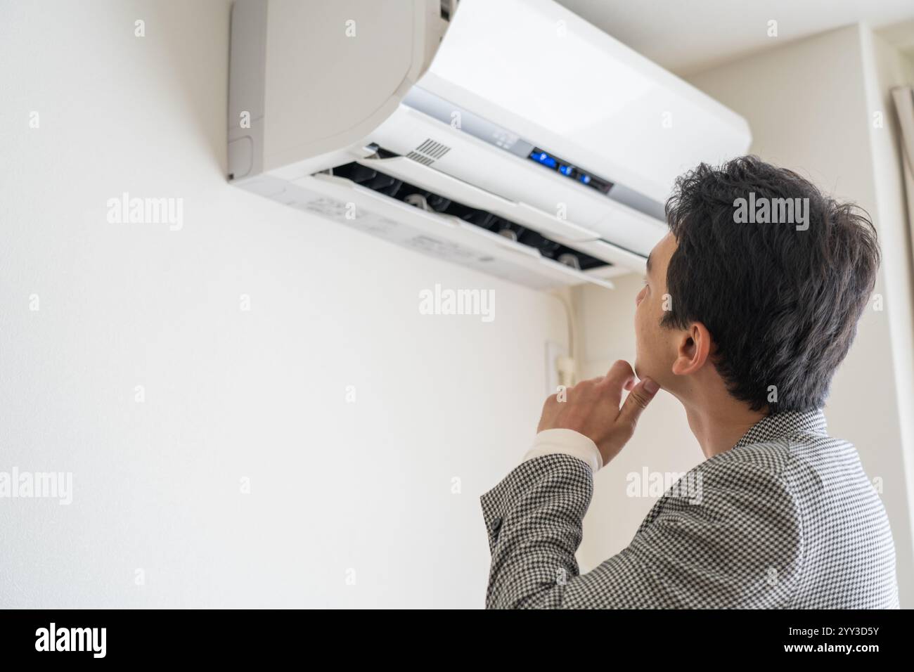 Young man air conditioner hi-res stock photography and images - Alamy