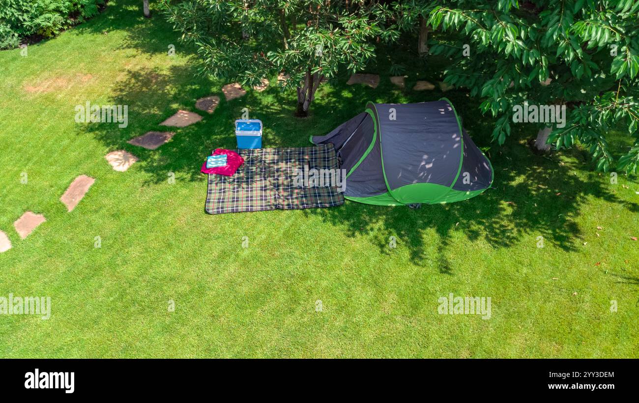 Aerial top view of campsite from above, tent and camping equipment ...