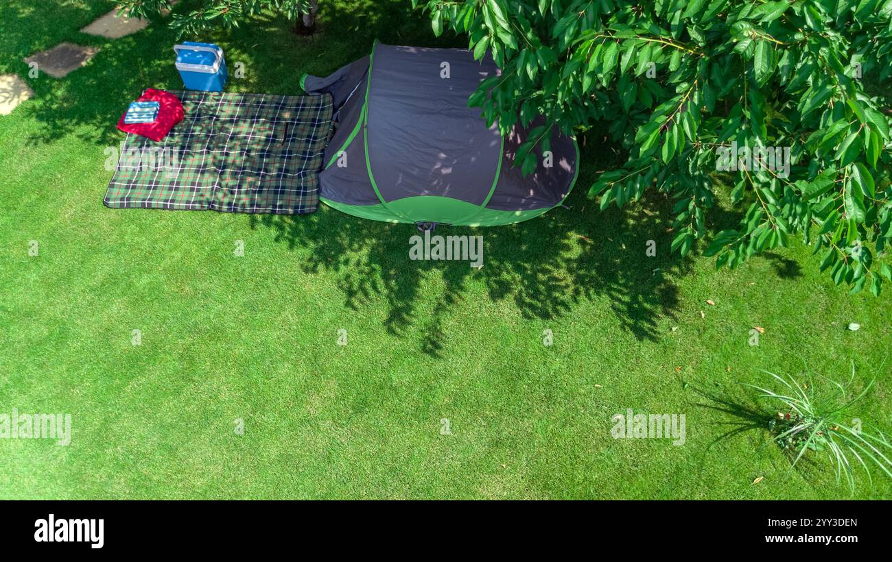 Aerial top view of campsite from above, tent and camping equipment ...