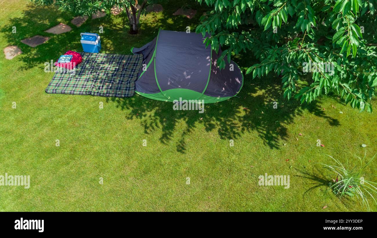 Aerial top view of campsite from above, tent and camping equipment ...