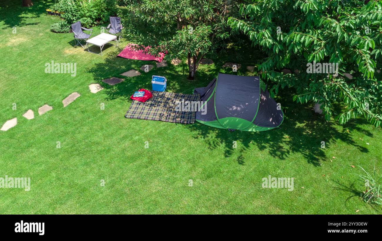 Aerial top view of campsite from above, tent and camping equipment ...