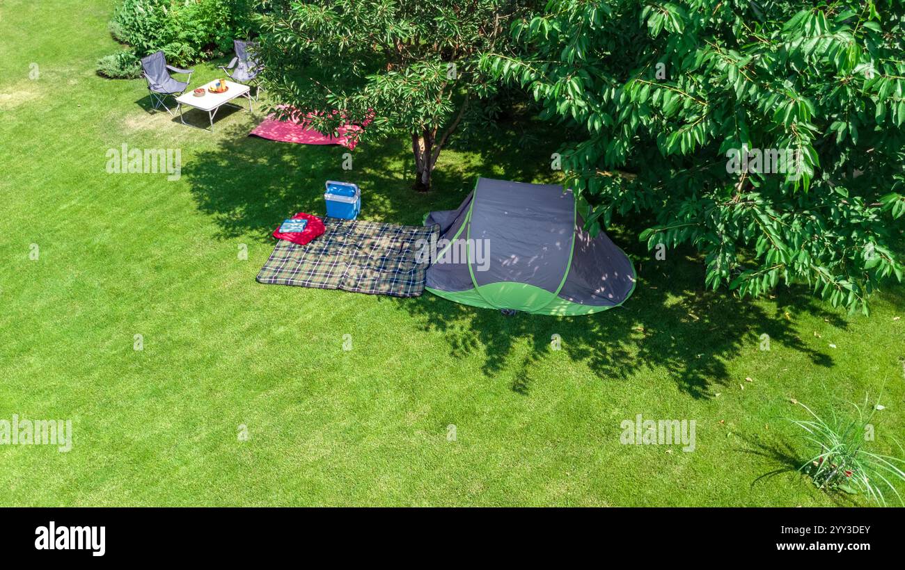 Aerial top view of campsite from above, tent and camping equipment ...